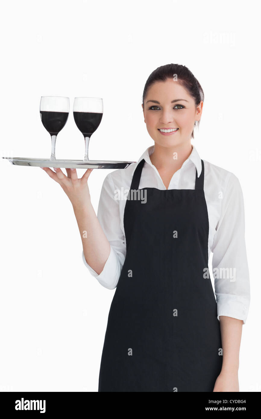 Pretty waitress holding two glasses of wine Stock Photo - Alamy
