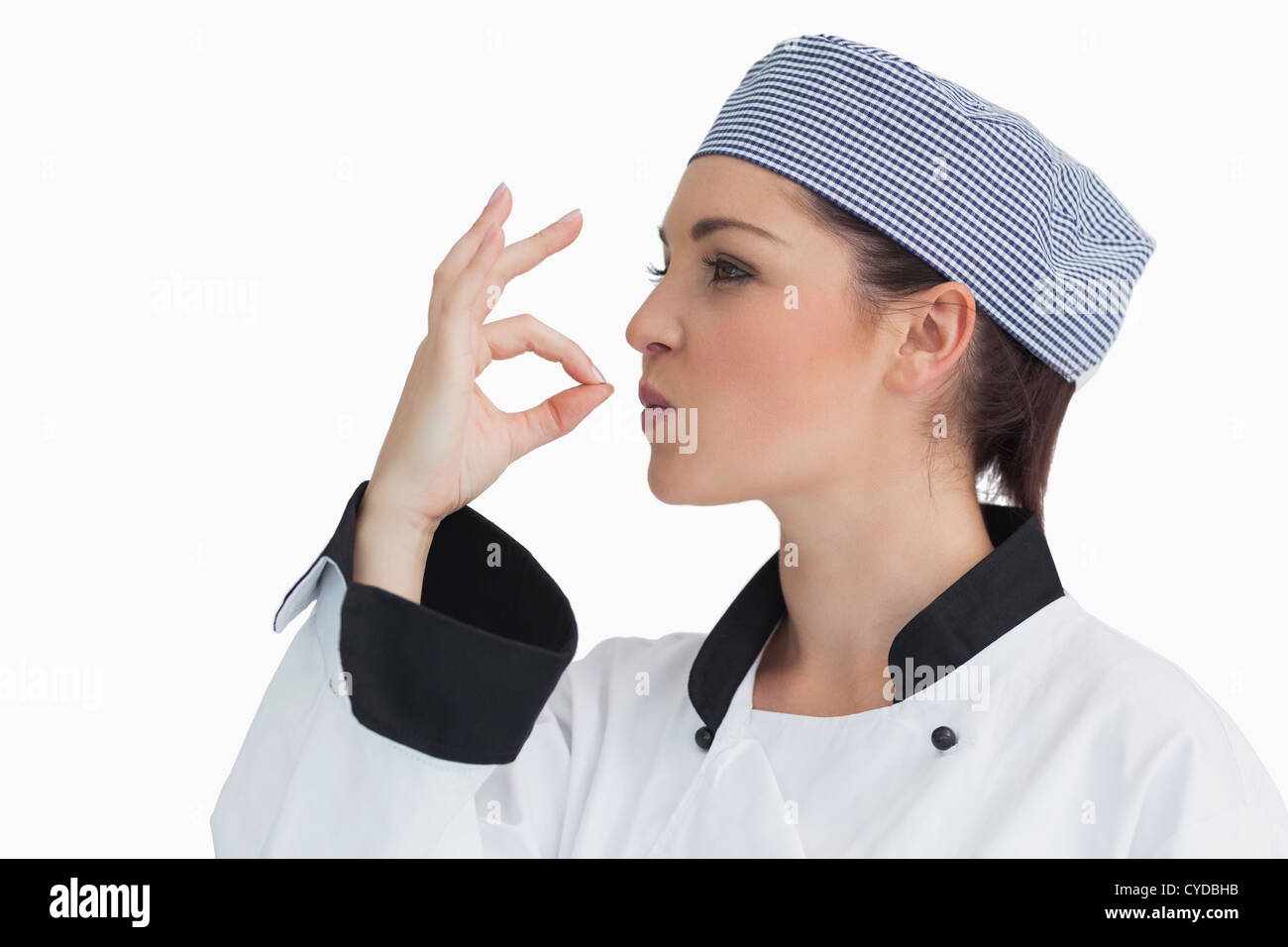 Chef making sign for tasty with her hands Stock Photo - Alamy