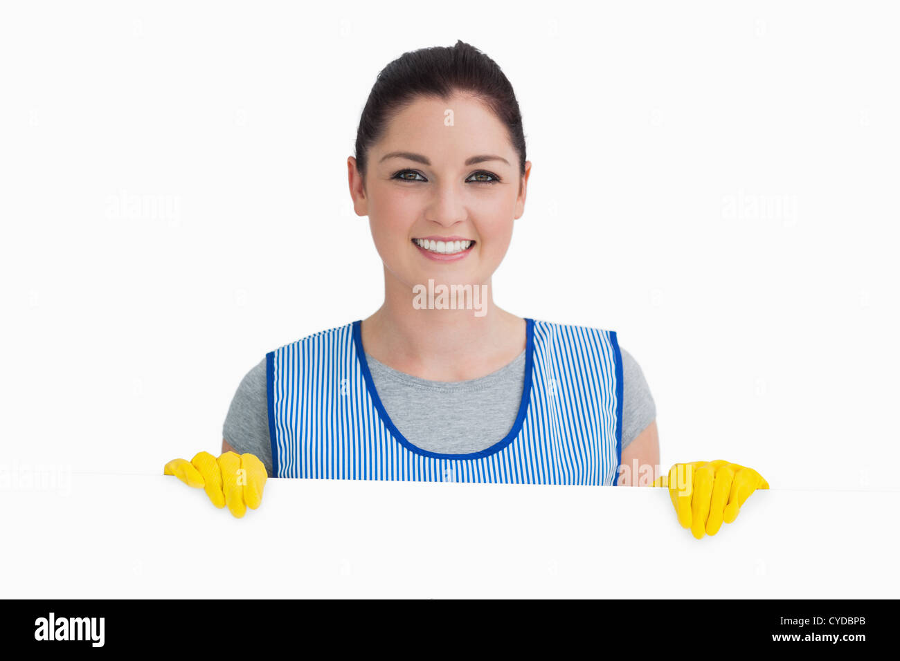 Smiling cleaning woman showing a white panel Stock Photo - Alamy