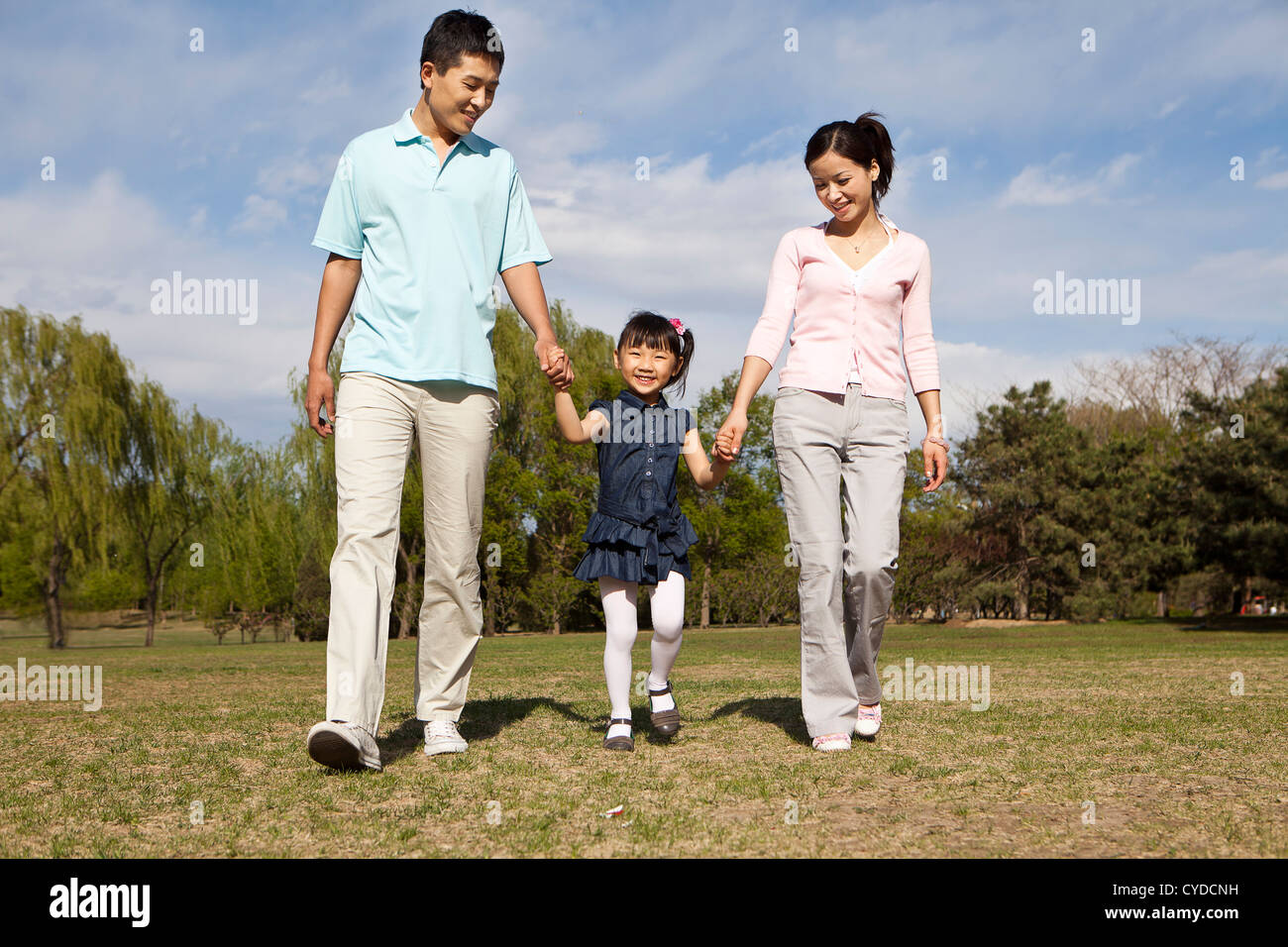 Chinese family of Three , standing on the lawn Stock Photo - Alamy