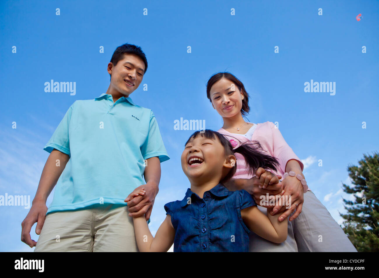 Chinese family of Three , standing on blue sky background Stock Photo ...