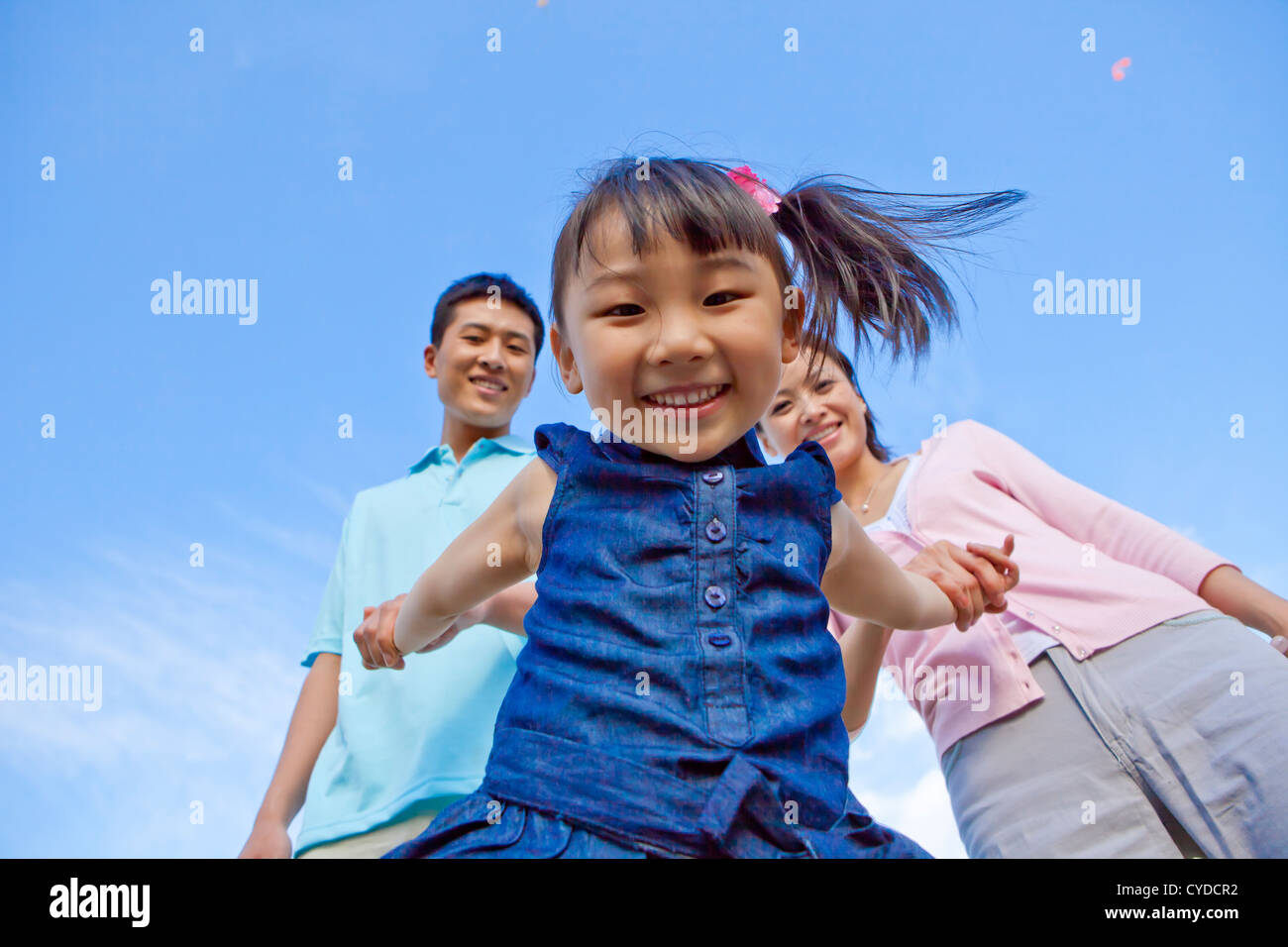 Chinese family of Three , standing on blue sky background Stock Photo ...