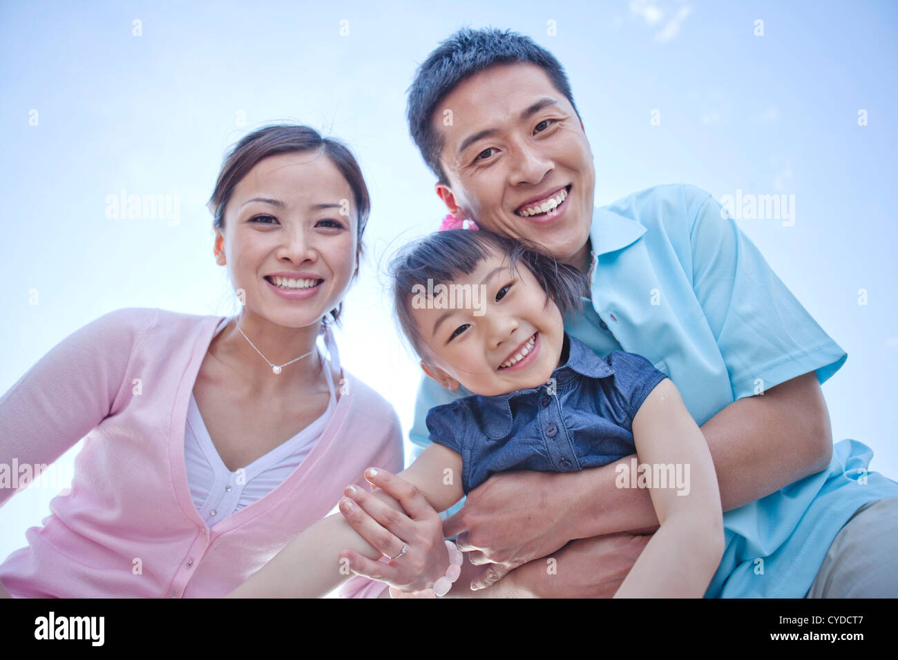 Chinese family of Three , standing on blue sky background Stock Photo ...