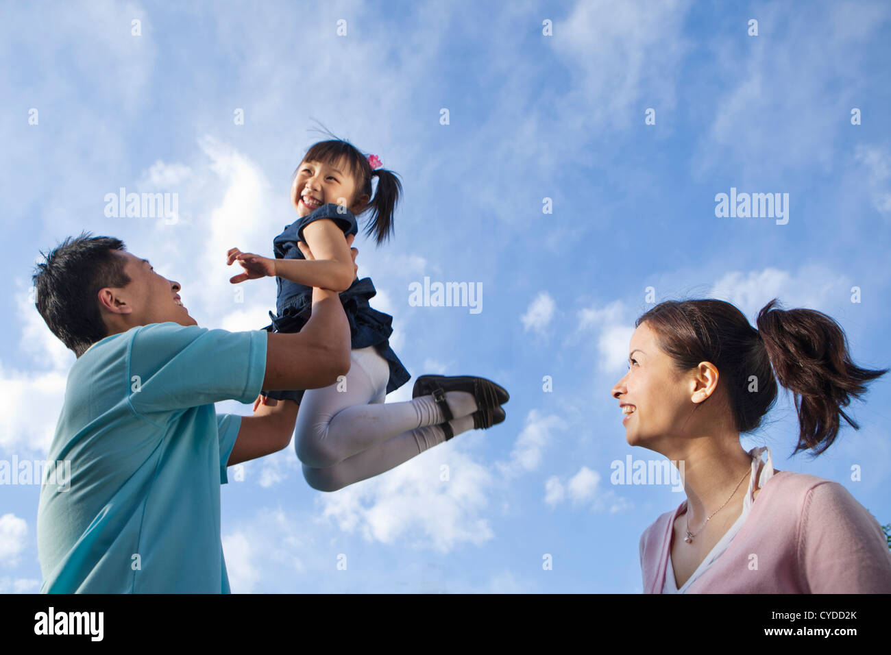 Chinese family of three, playing on the blue sky background Stock Photo ...