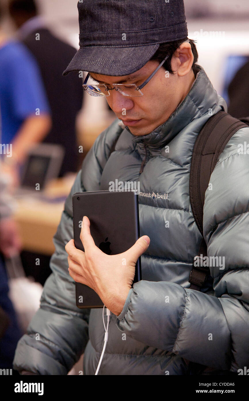 November 2, 2012, Tokyo, Japan - A customer holds the new iPad mini ...