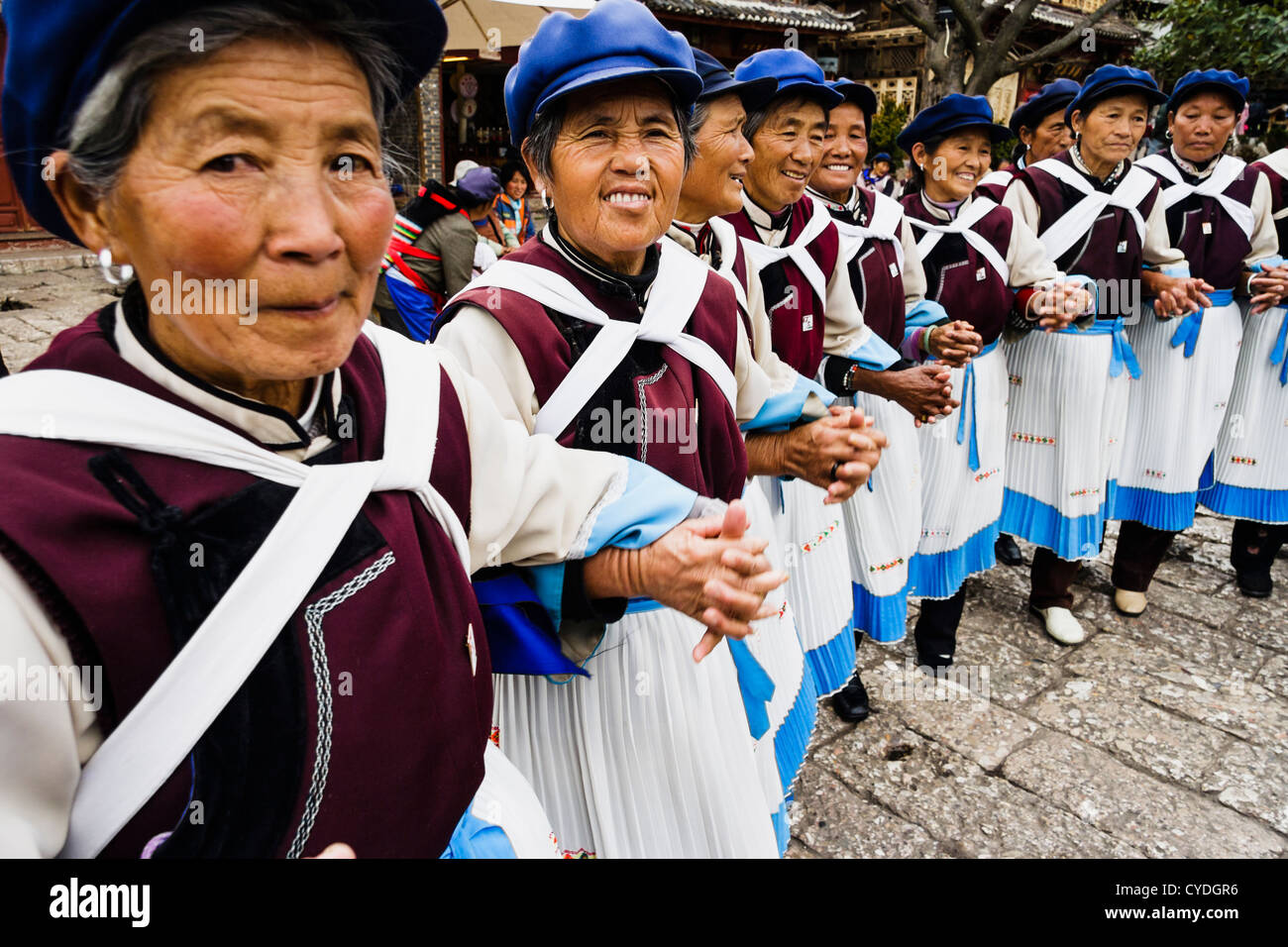Naxi women in traditional costume dancing in Lijiang Old Town, Yunnan ...