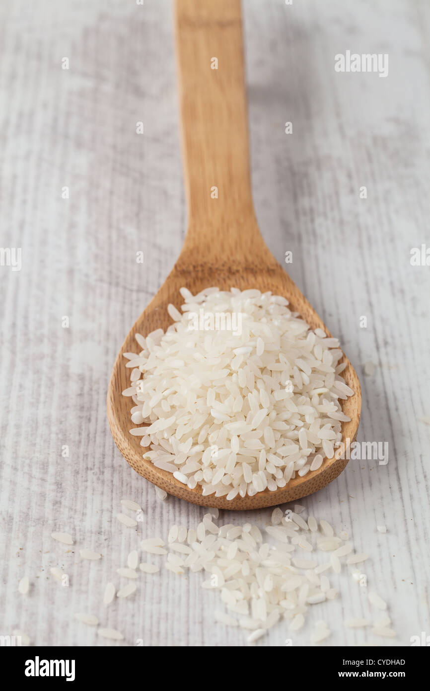 Bunch of white rice on a wooden spoon Stock Photo - Alamy