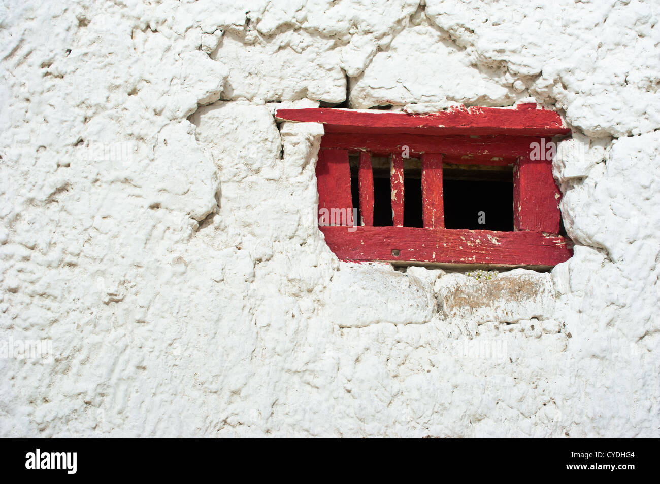Old red window frame on white wall at Buddhist monastery. India, Ladakh ...