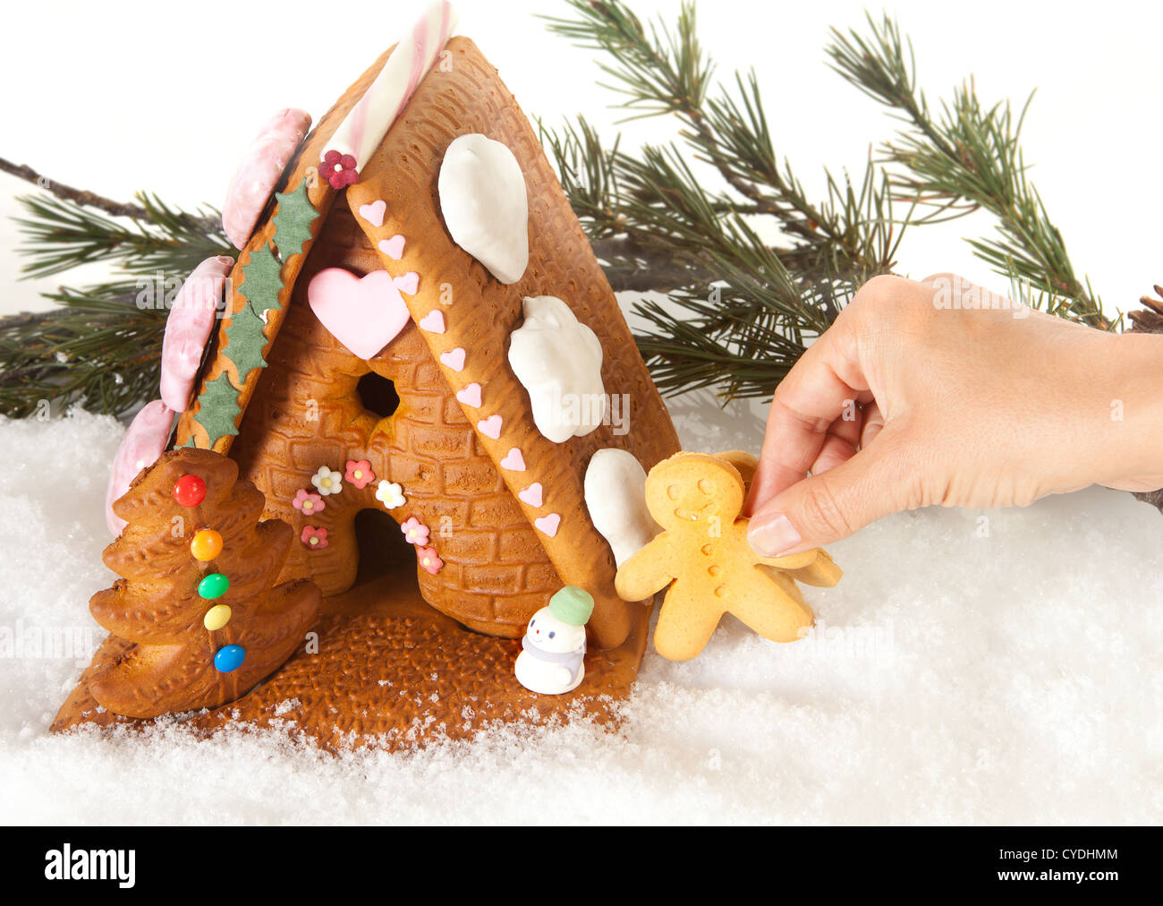 Hands adding gingerbread men to a christmas gingerbread house Stock ...