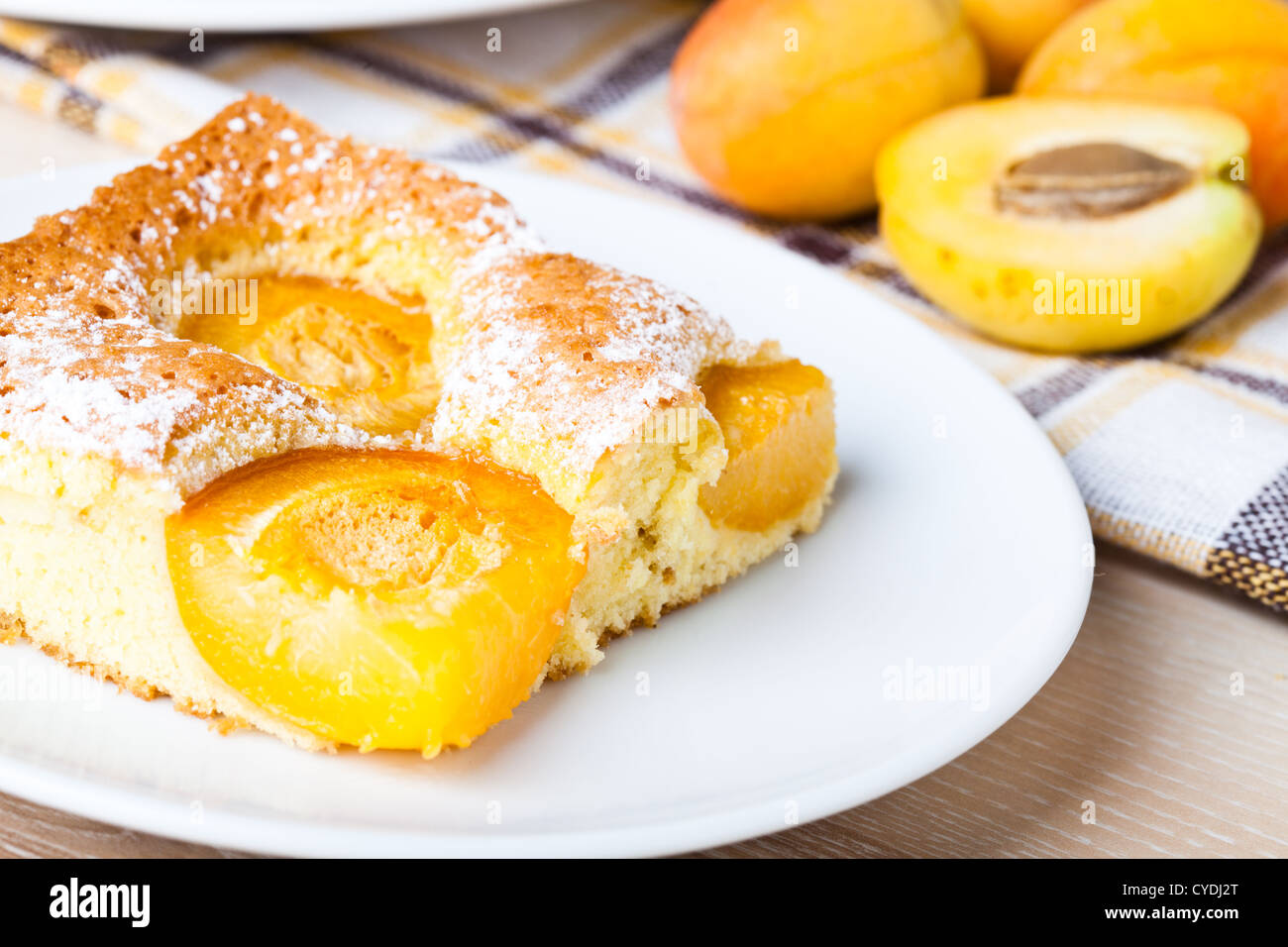 Slices of fresh apricot iced sponge cake with fruits Stock Photo - Alamy