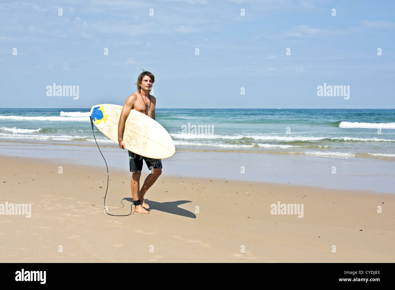 Surfer and his surfboard at the beach ready to surf Stock Photo - Alamy