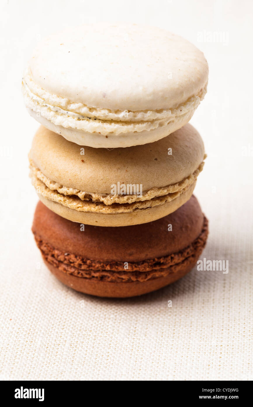 Three colors of macaroons in brown and beige tones Stock Photo - Alamy