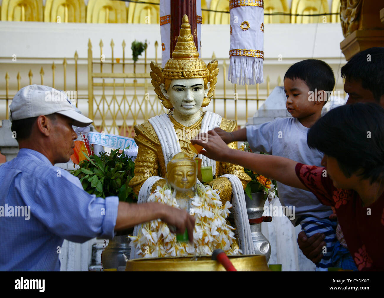 People Putting Water On A Statue In Shwedagon Pagoda, Rangoon, Myanmar ...