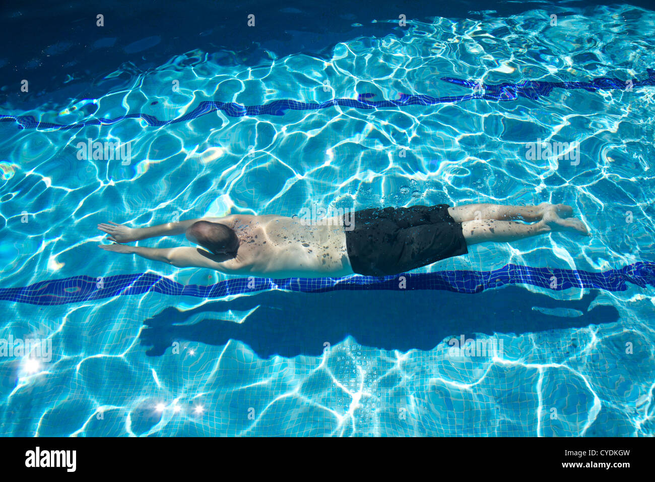 man with swimsuit swimming on a blue water pool Stock Photo - Alamy