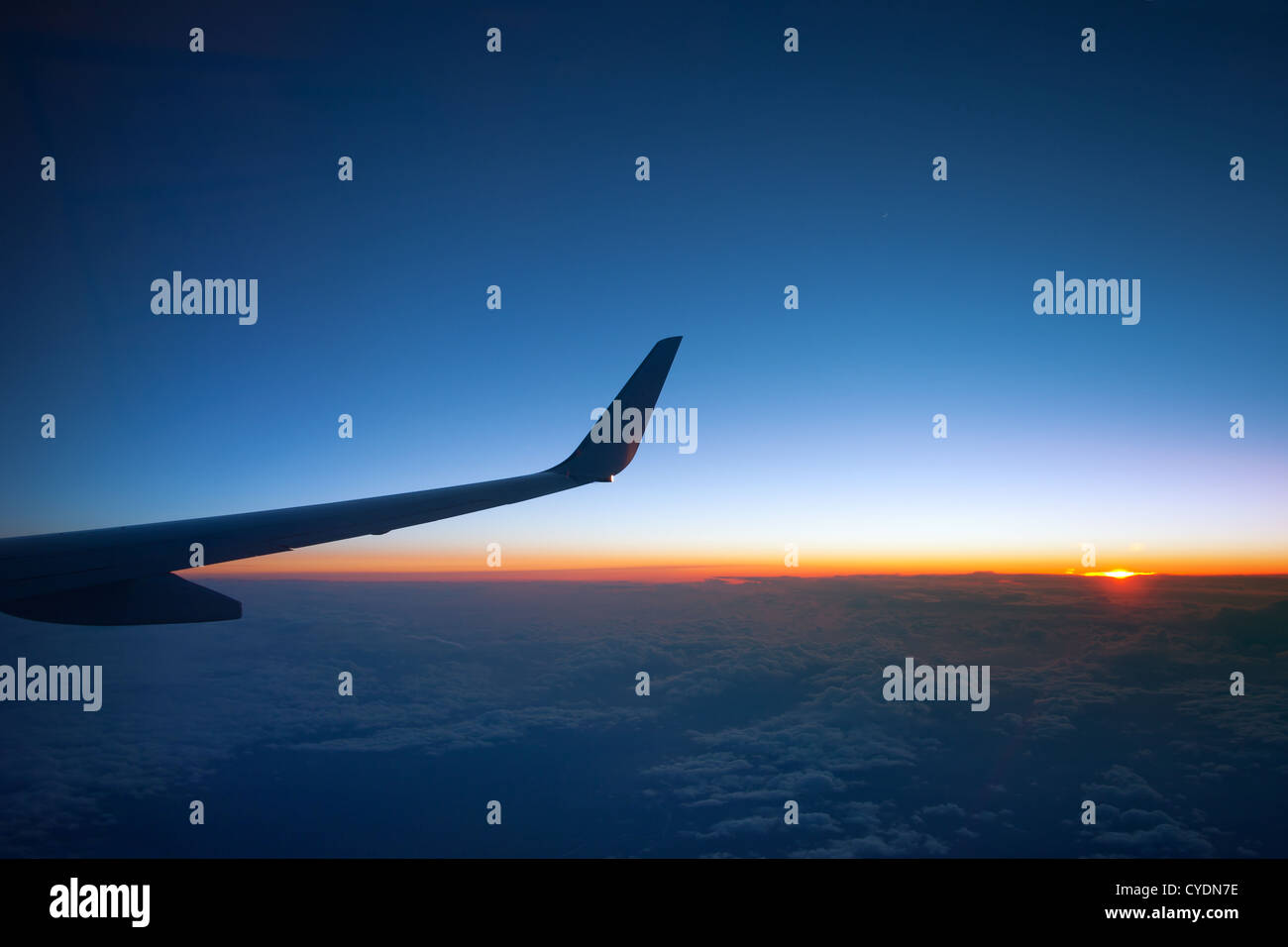 Above the clouds - sunset with airplane wing Stock Photo - Alamy