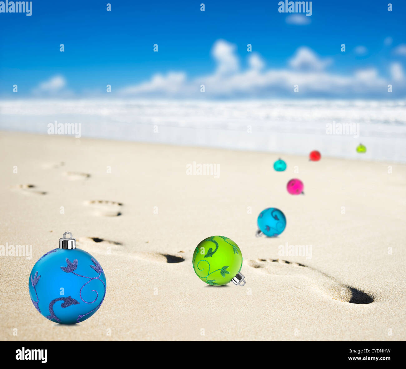 Christmas baubles on a beach with footprints Stock Photo - Alamy