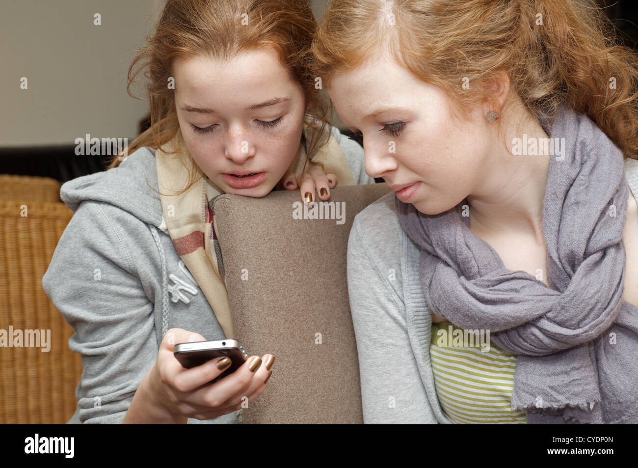 Teenage girls texting a message on a mobile phone Stock Photo - Alamy