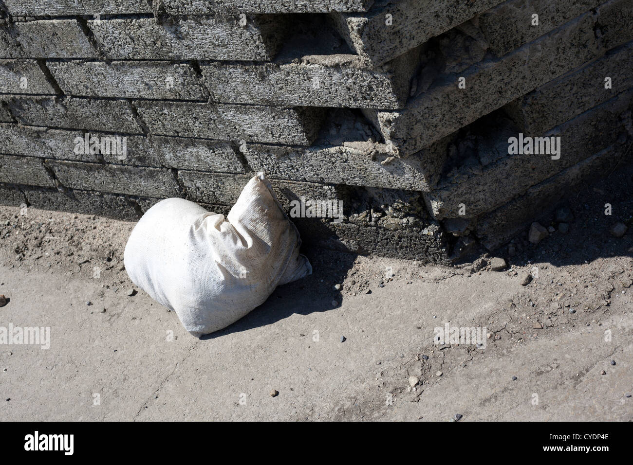sack leaning against a wall Stock Photo - Alamy