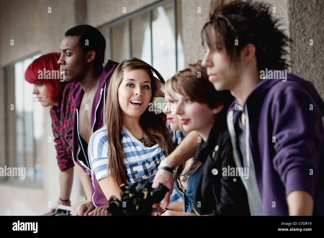 The camera focuses on the attractive young smiling punk girl as her ...