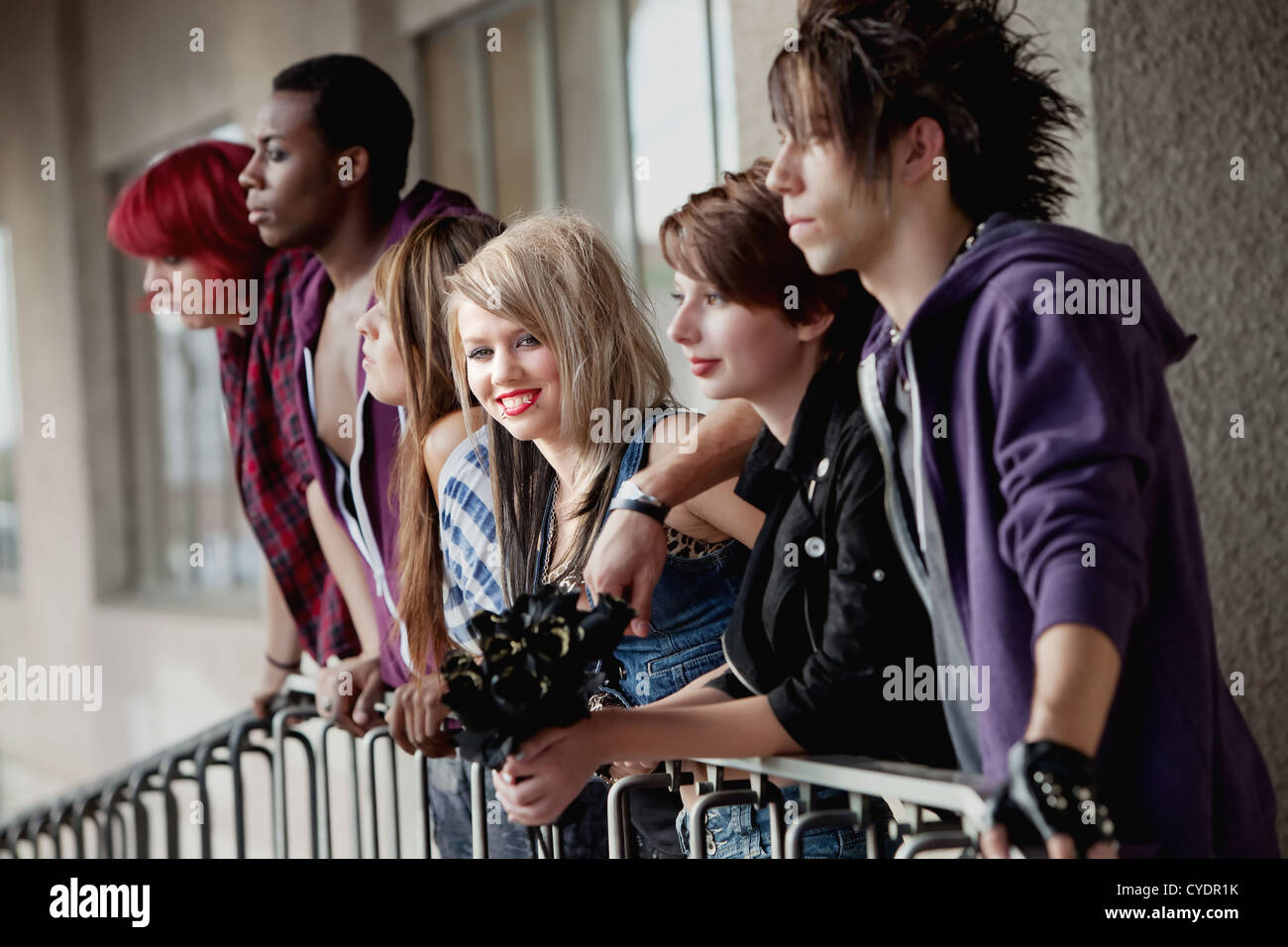 Attractive young teen punk girl with scene hair looks towards the ...