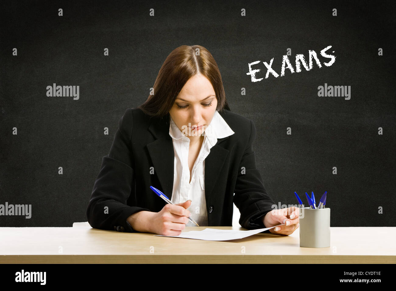 photo of student sitting at desk having her exams Stock Photo - Alamy