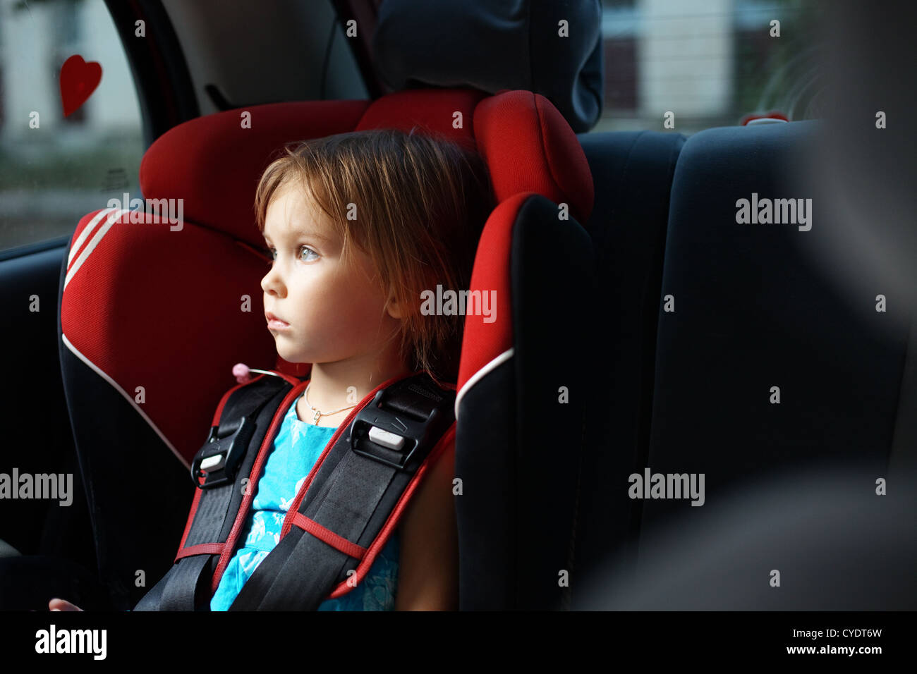 Child in auto baby seat in car looking at window Stock Photo - Alamy