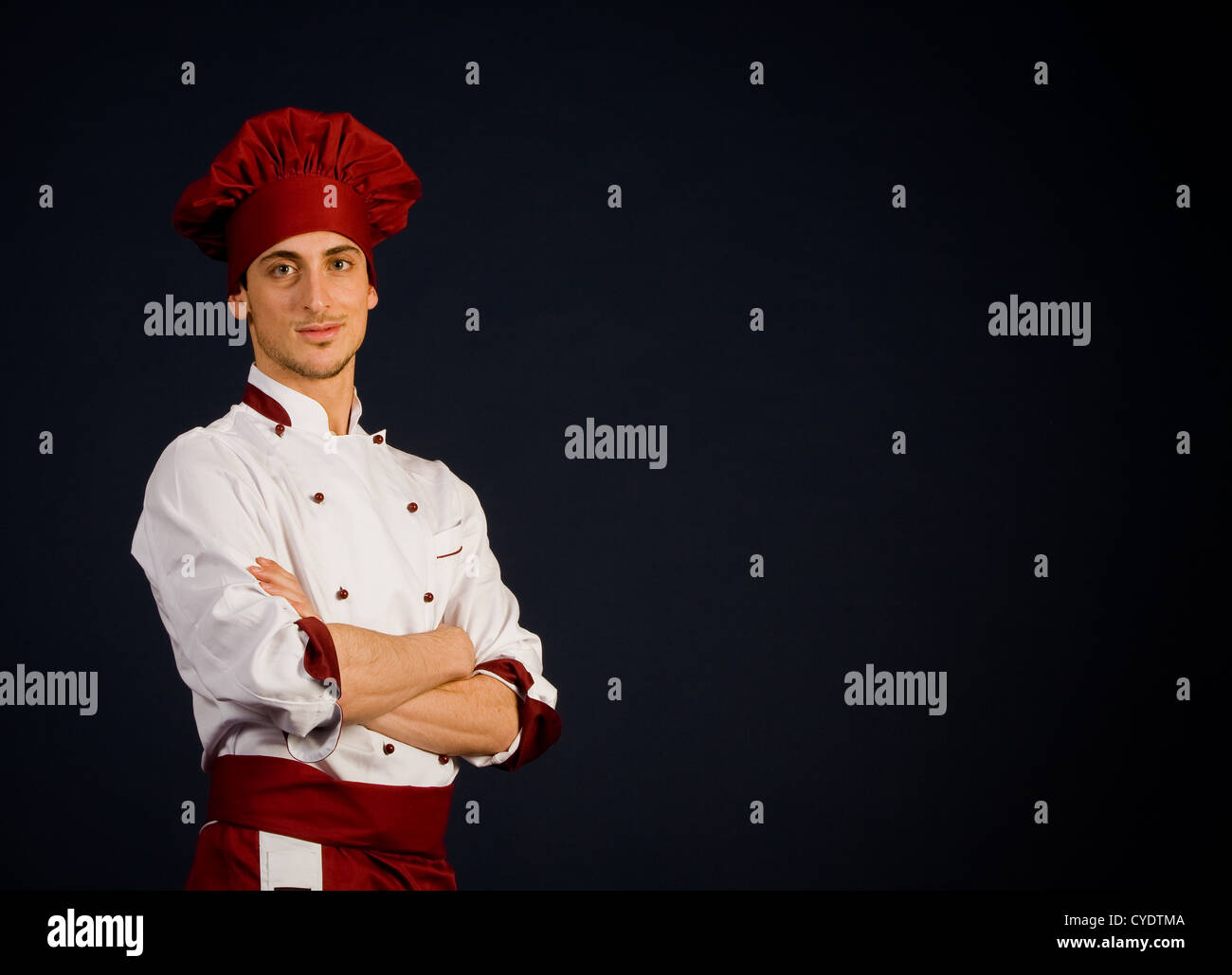 photo of young successful chef in front of a blue background Stock ...
