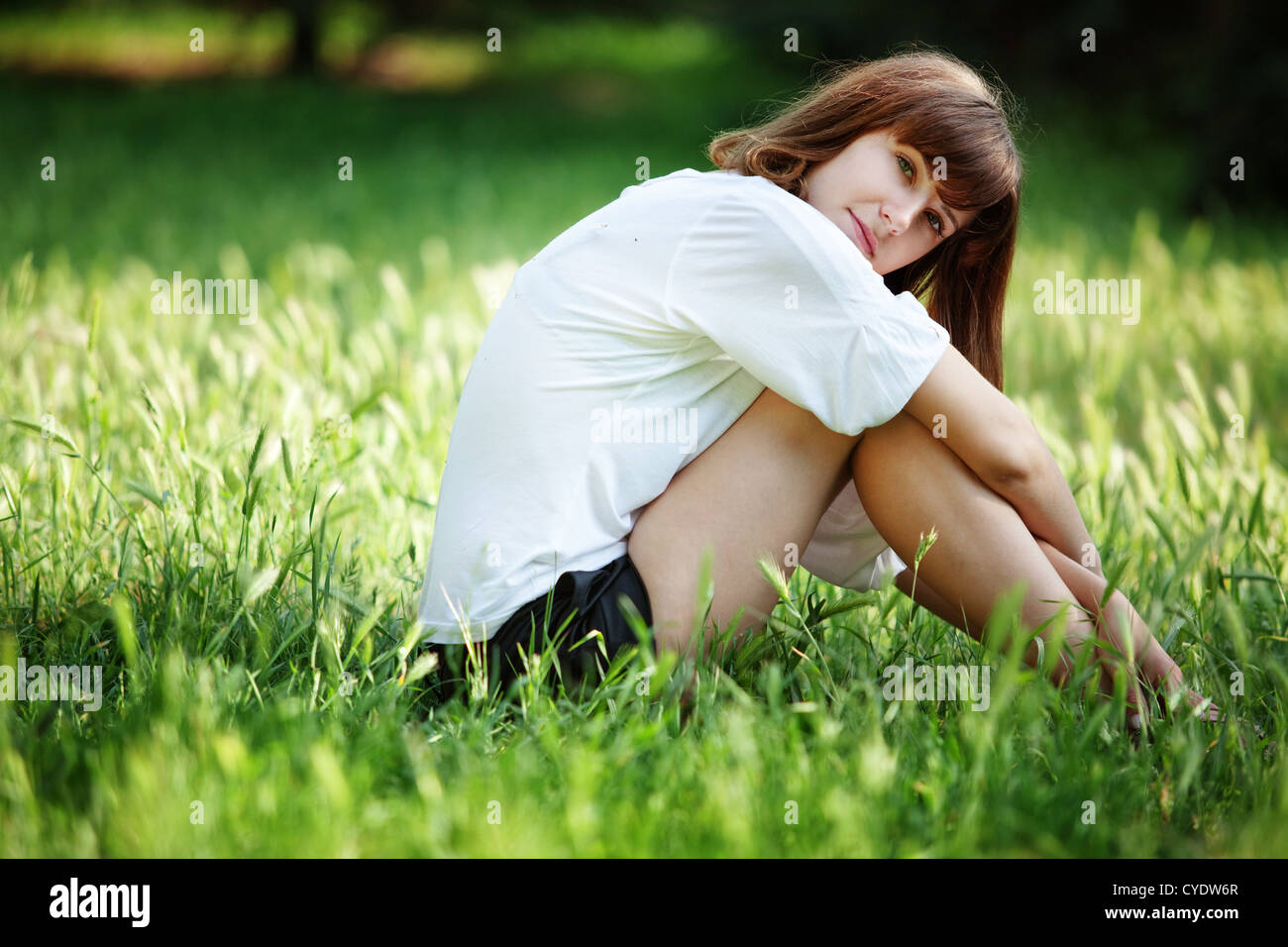 Girl resting in grass Stock Photo - Alamy