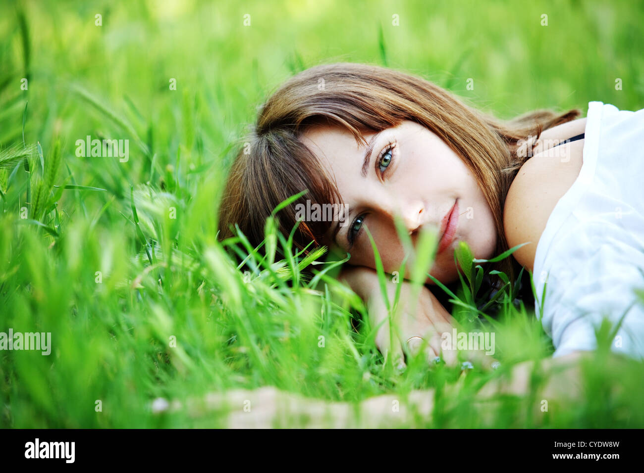 Girl resting in grass Stock Photo - Alamy