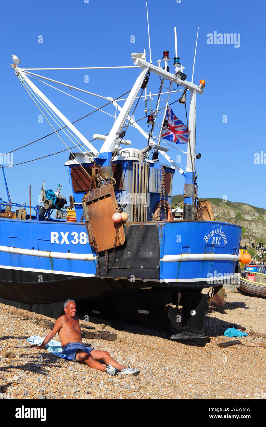 Man sunbathing at the beach hi-res stock photography and images - Alamy