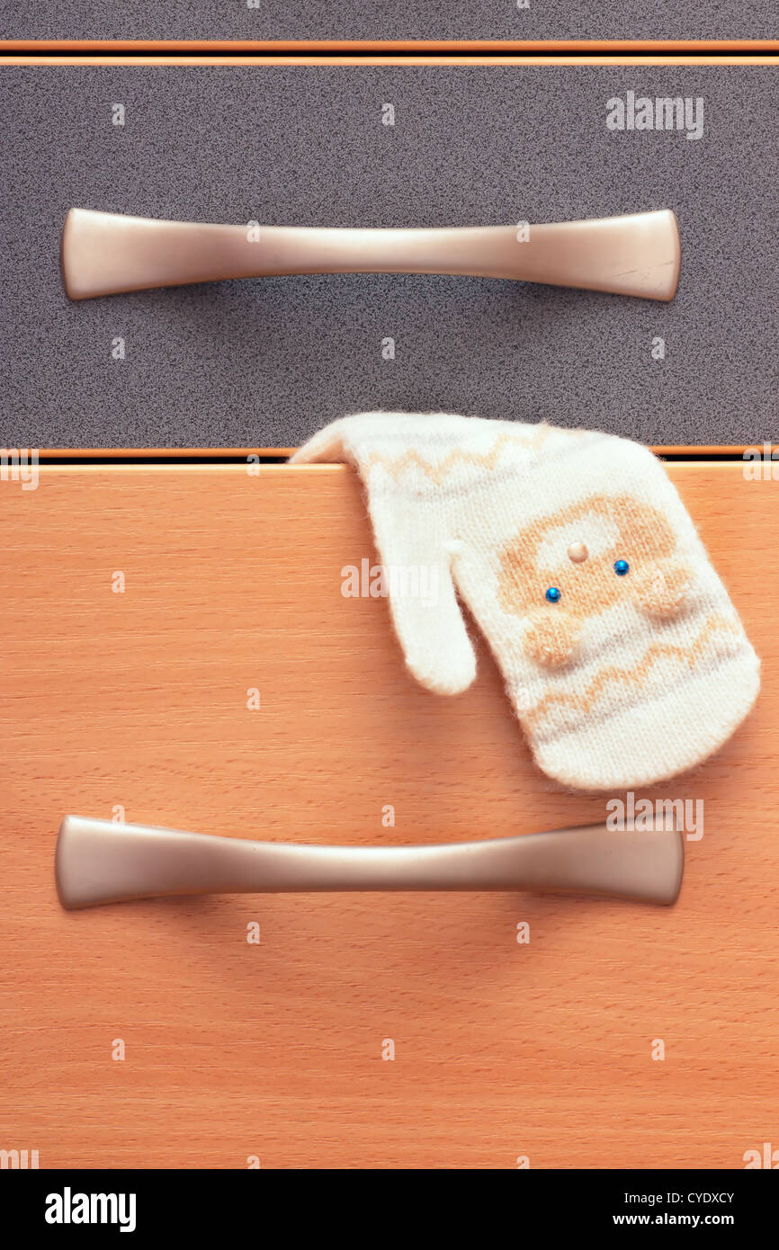 A mitten hanging out of a cupboard Stock Photo - Alamy