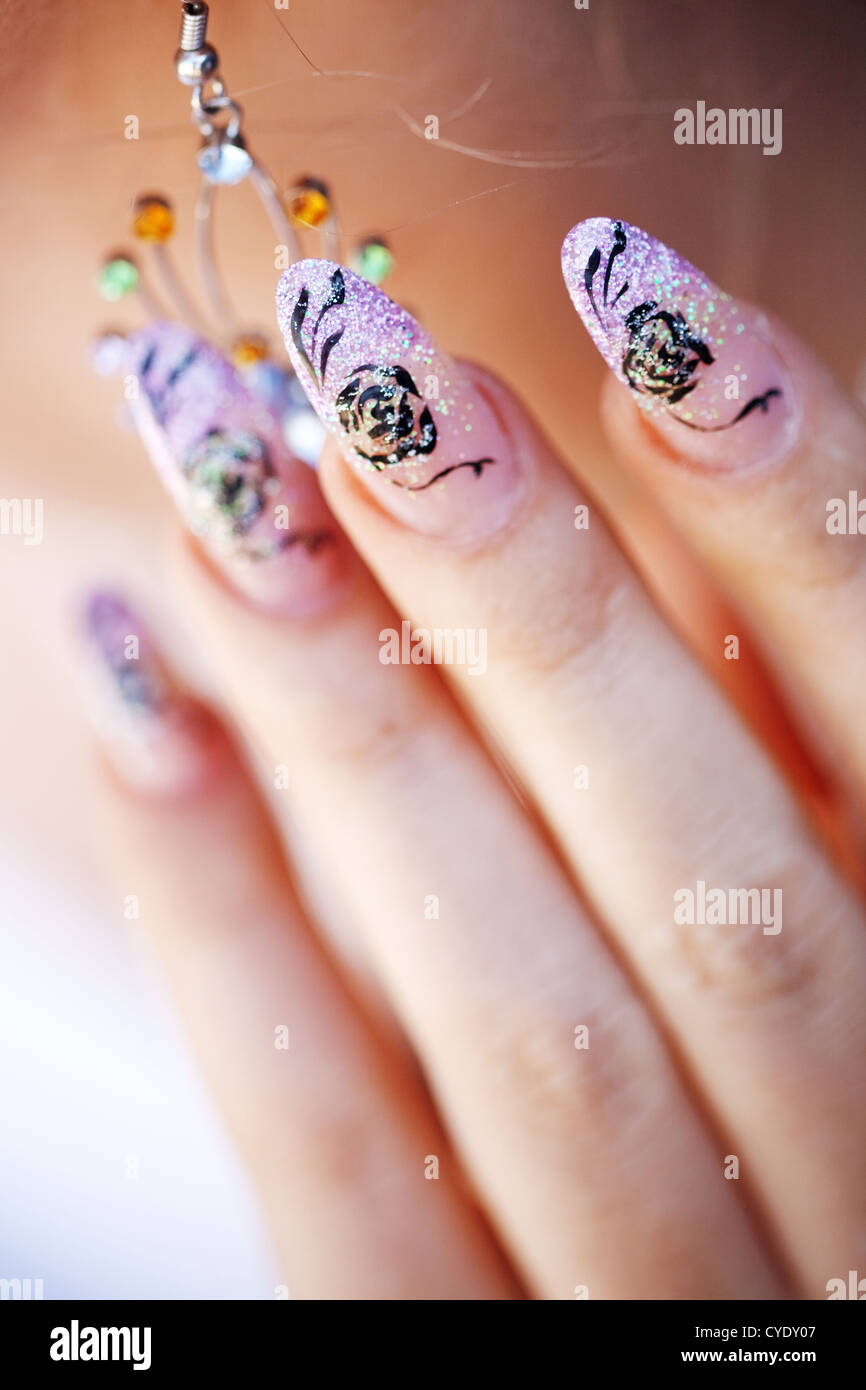 Close-up shot of art manicure with painted nails Stock Photo - Alamy