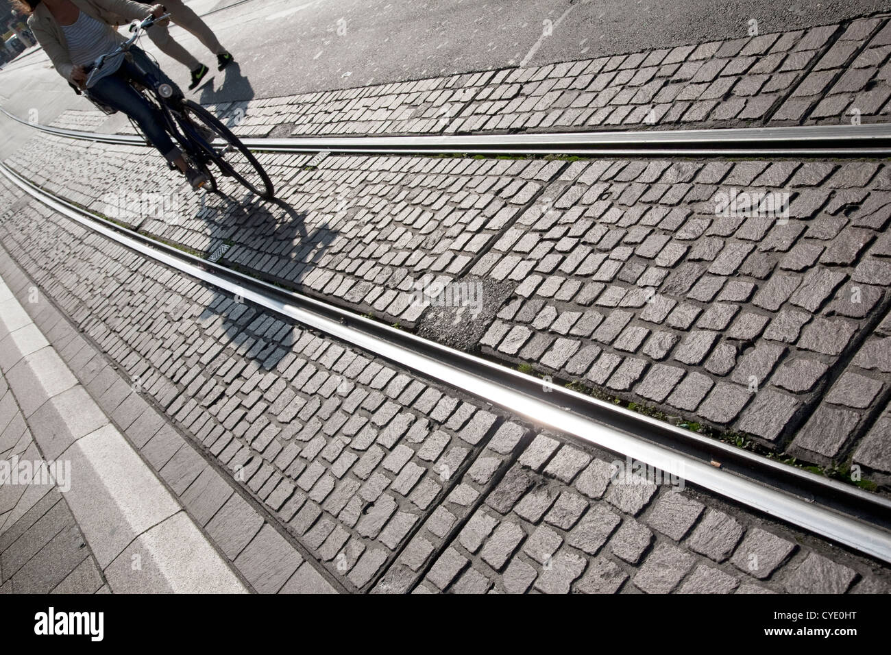 Woman Cycling on Tram Track Stock Photo - Alamy