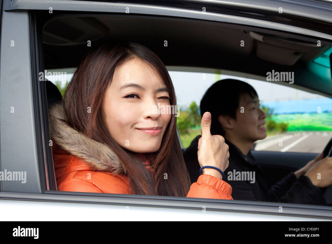 Happy smiling couple Driving in the car with thumbs up Stock Photo - Alamy