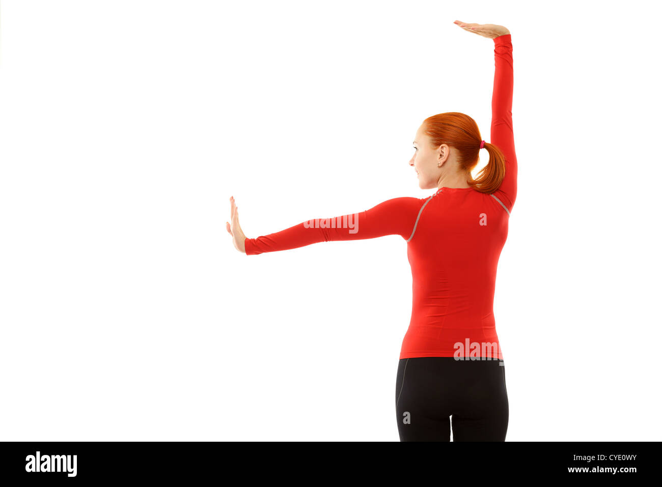 Beautiful young red woman performing fitness exercises over white ...