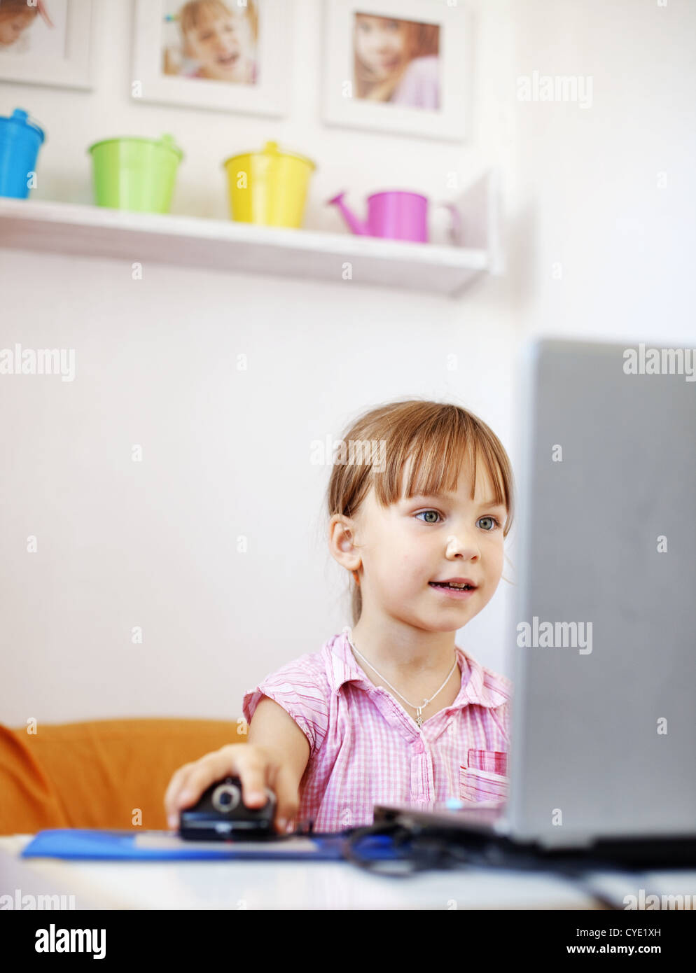 Kid girl with laptop Stock Photo - Alamy