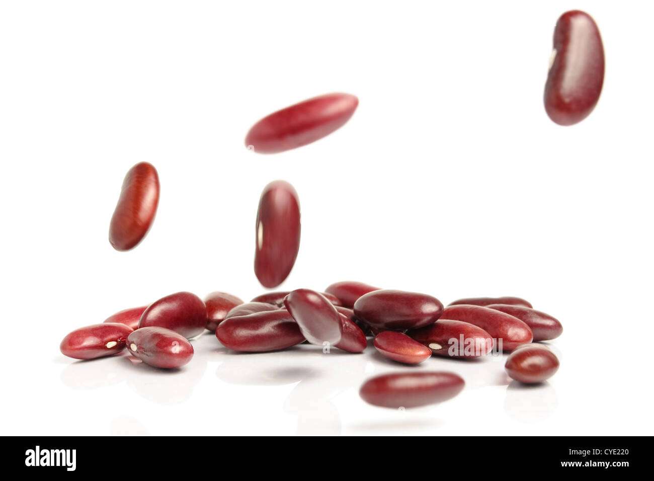 Falling red beans on white background Stock Photo - Alamy