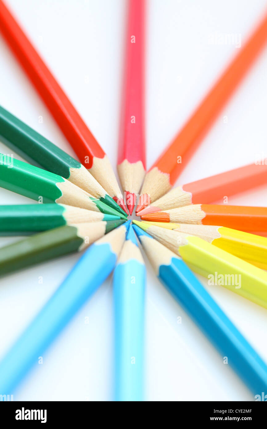 Color pencils in arrange in color wheel colors on white background ...