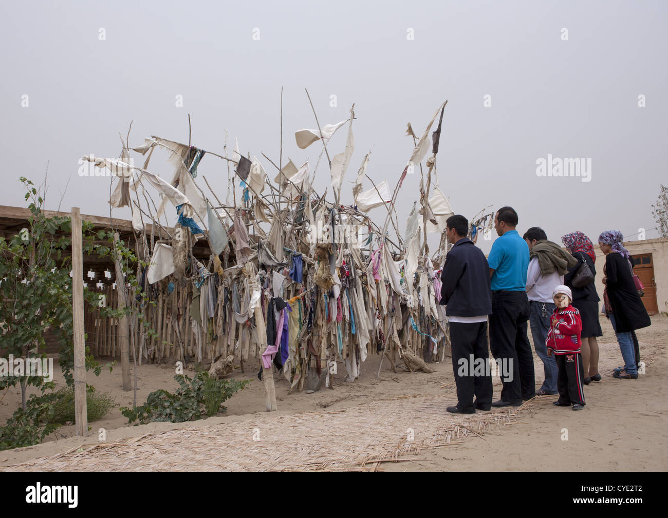 Family Praying At Imam Asim Tomb In The Taklamakan Desert, Xinjiang ...