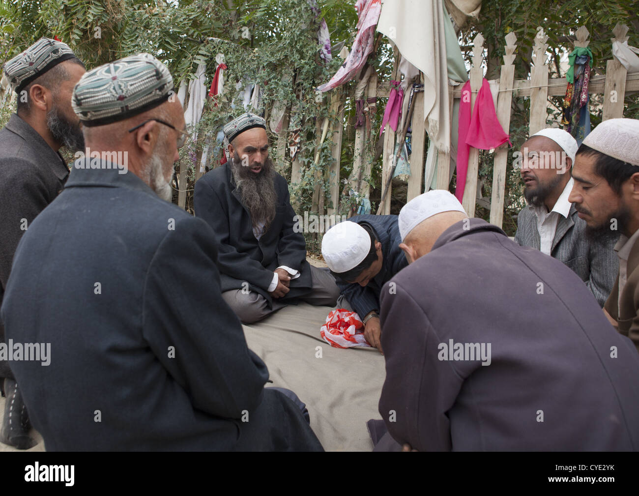 Uyghur Sufi Men Praying At Imam Asim Tomb In The Taklamakan Desert ...