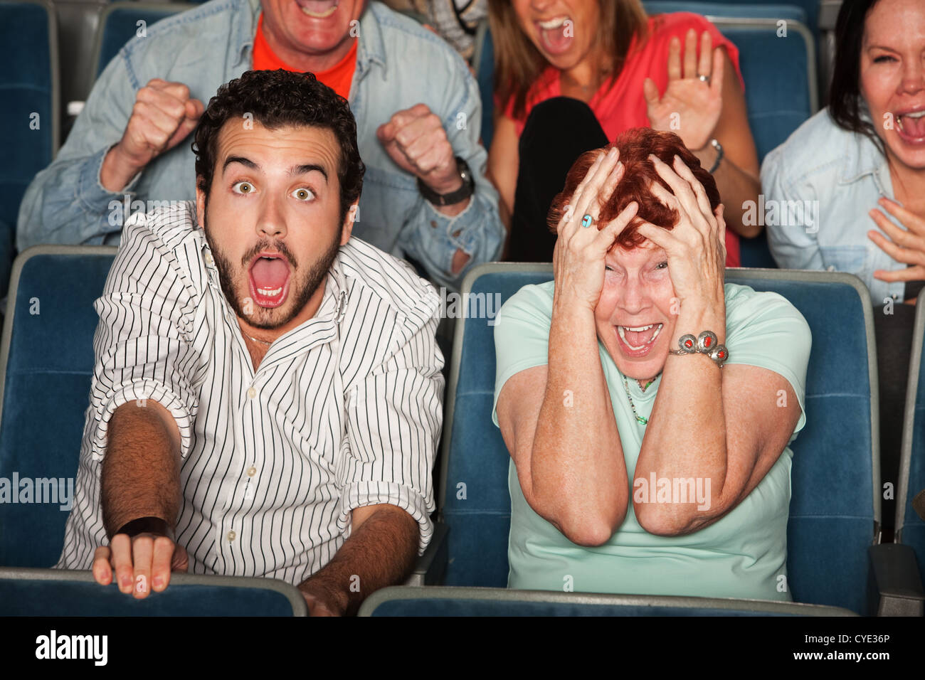 Group of frightened people in a theater Stock Photo - Alamy