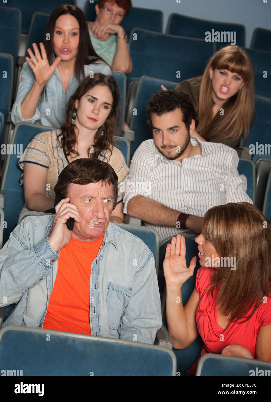 Man on phone call irks audience in theater Stock Photo - Alamy