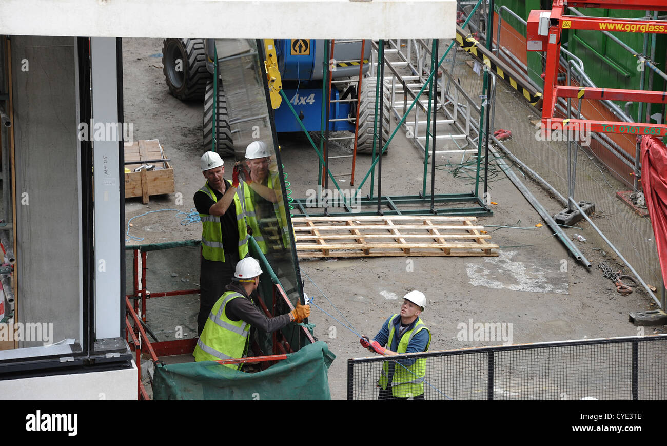 Builders installing large windows for new building in Northwest London ...