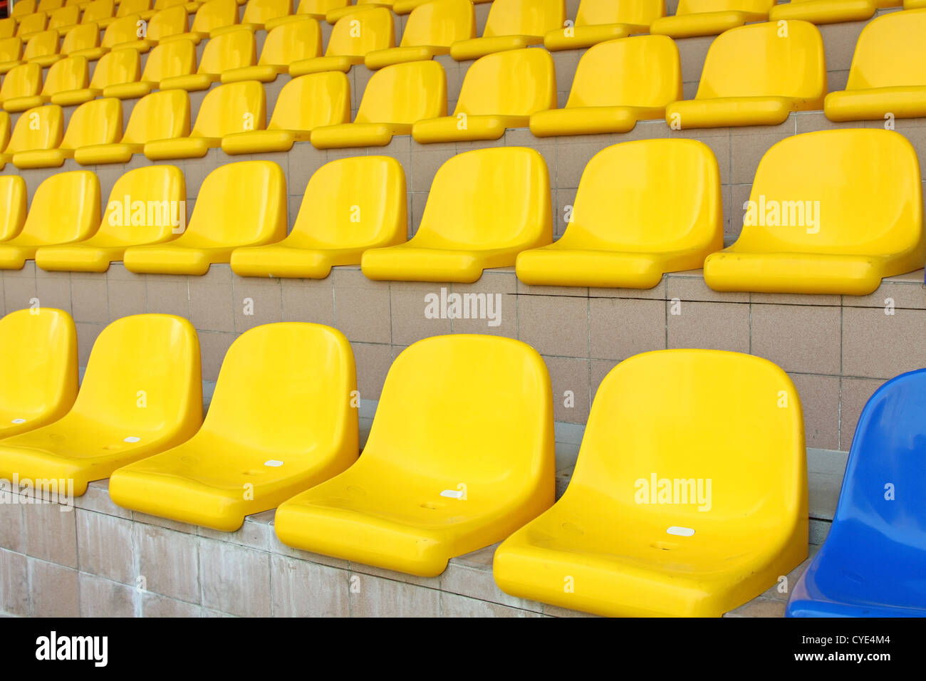 Stadium seats in blue and yellow color Stock Photo - Alamy
