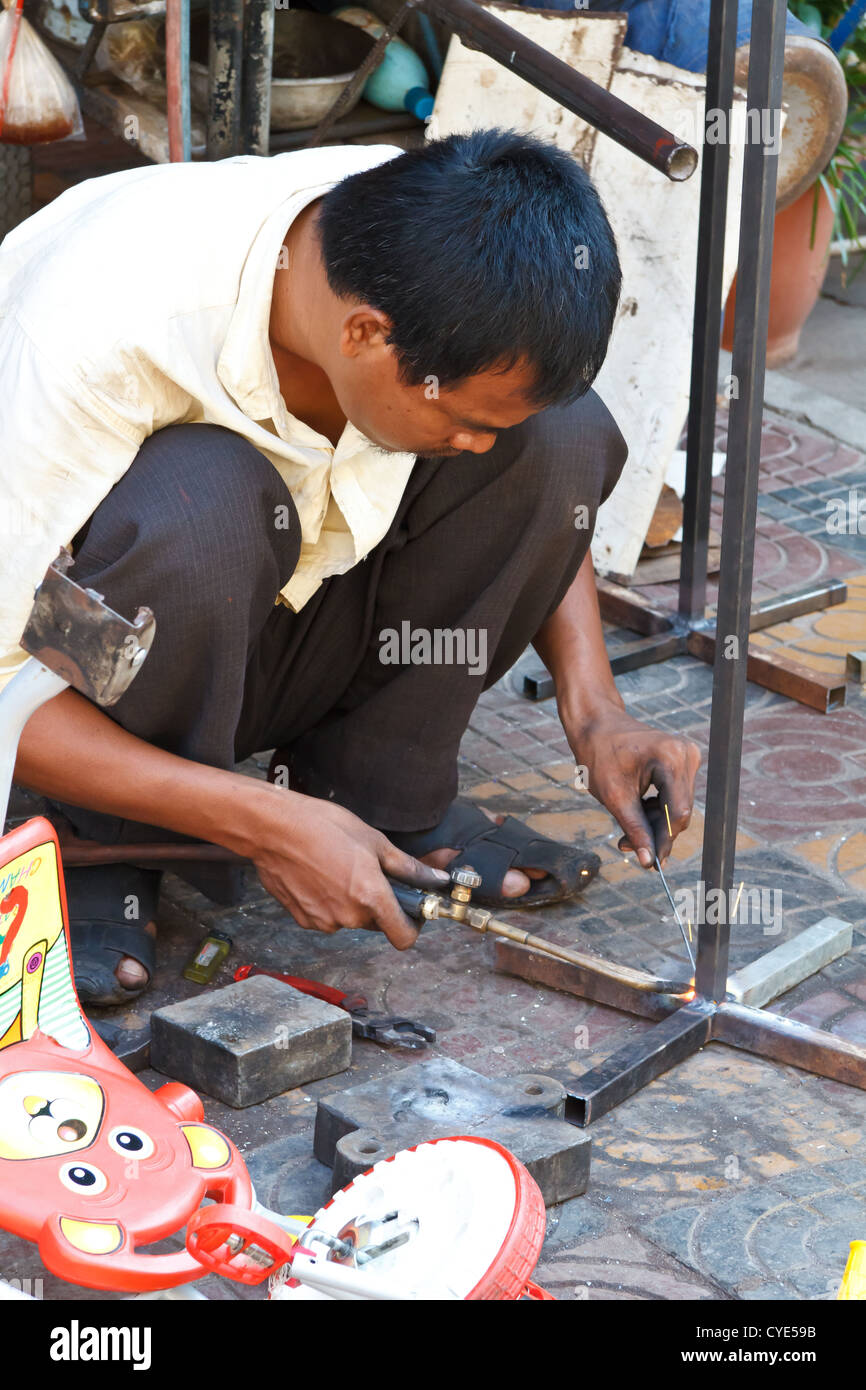 Man working in the Street in Phnom Penh, Cambodia Stock Photo - Alamy