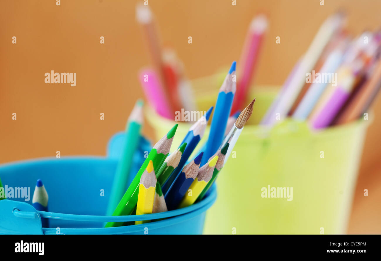 Colorful pencils in storage buckets Stock Photo - Alamy