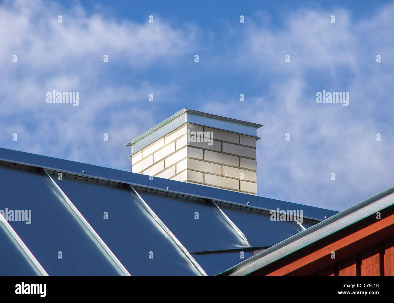 New metal shiny roof with white bricks chimney Stock Photo - Alamy