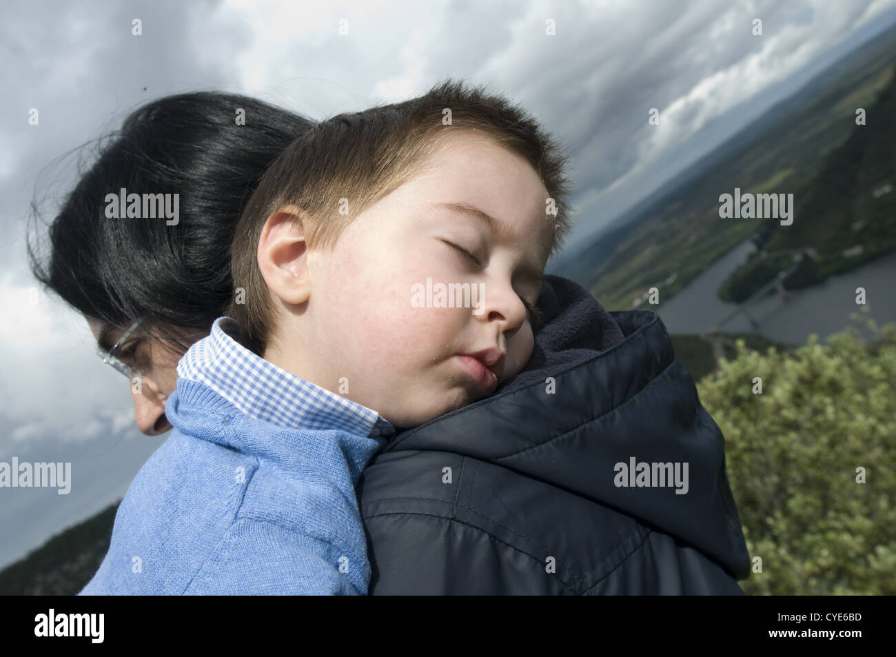 2 year old kid sleeping over his mothers shoulder Stock Photo - Alamy