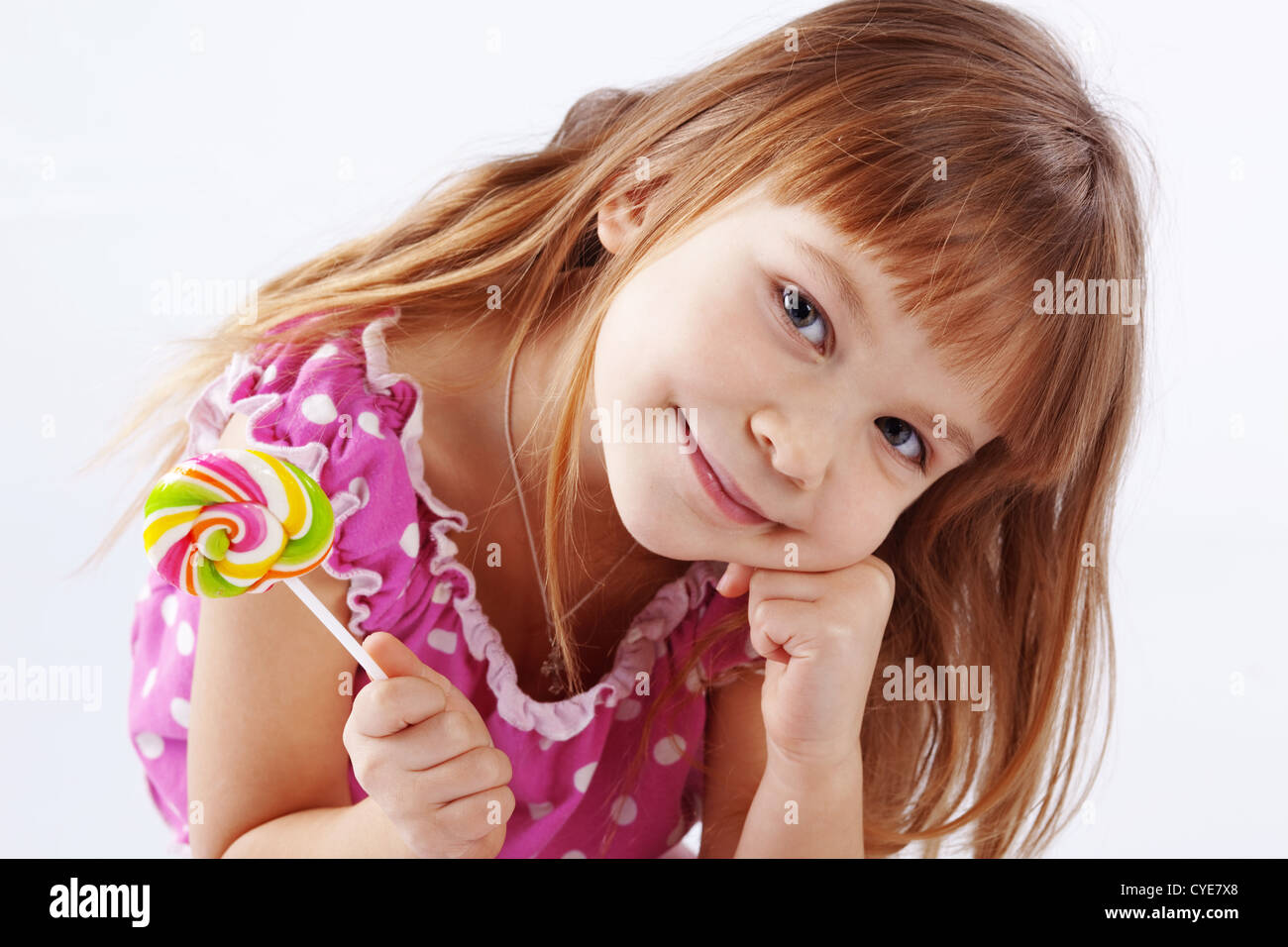 Portrait of funny child eating sweet candy Stock Photo - Alamy