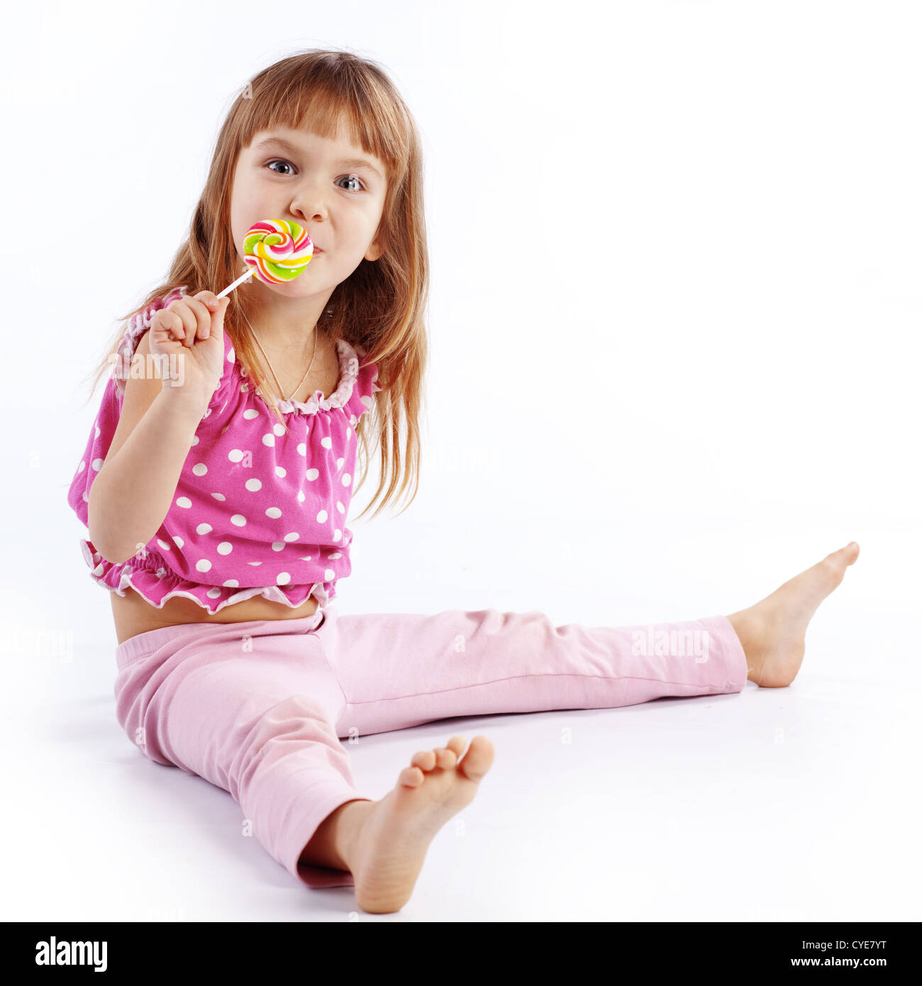 Portrait of funny child eating sweet candy Stock Photo - Alamy